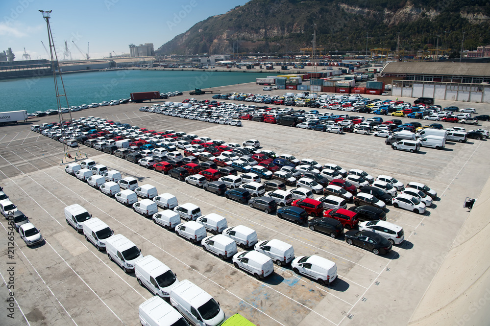 rows of cars on parking in sea port. Car export and import business ...