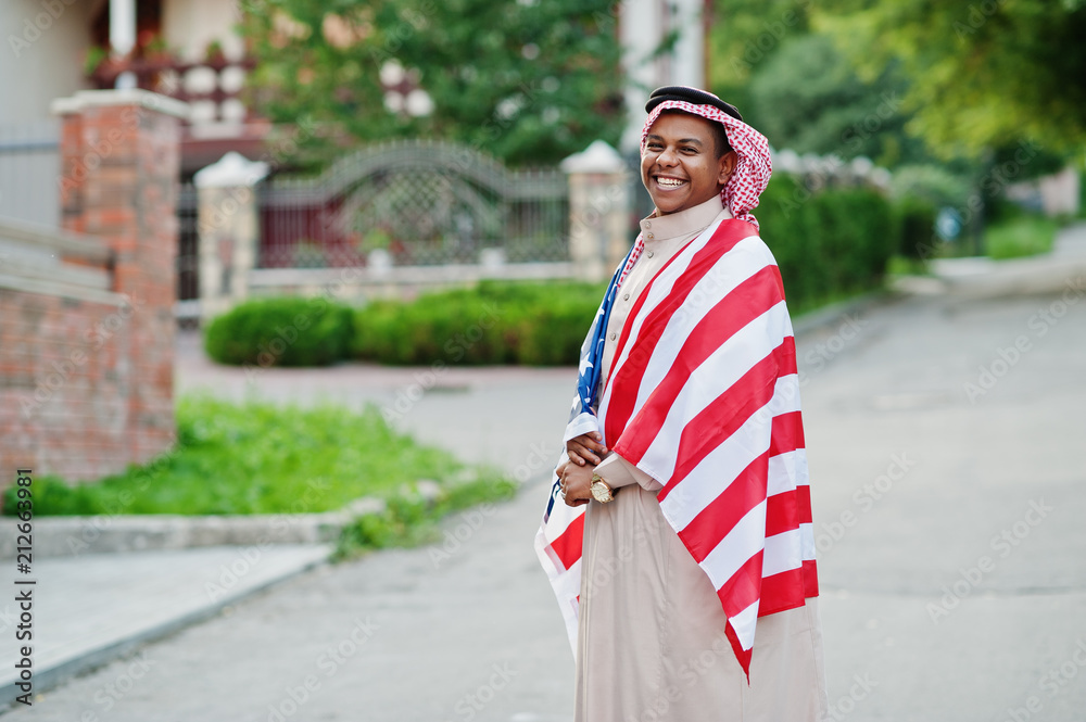 Middle Eastern arab man posed on street with USA flag. America and ...