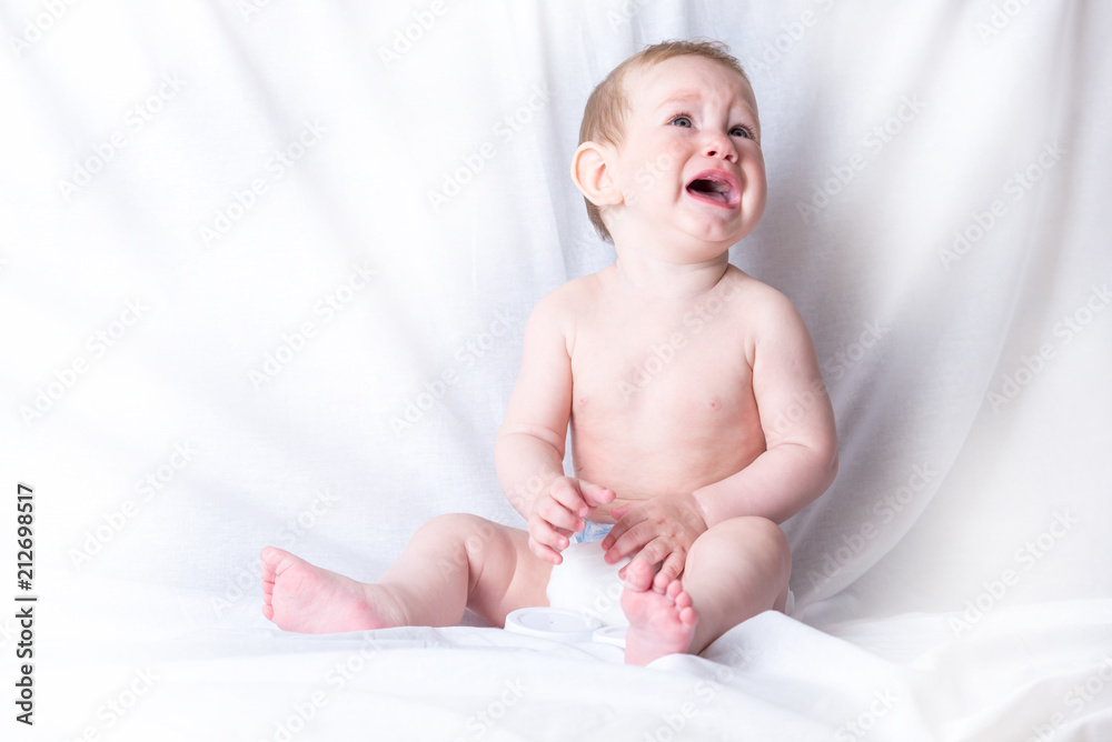 Cute baby 6-9 months old sad crying white background. Children's ...