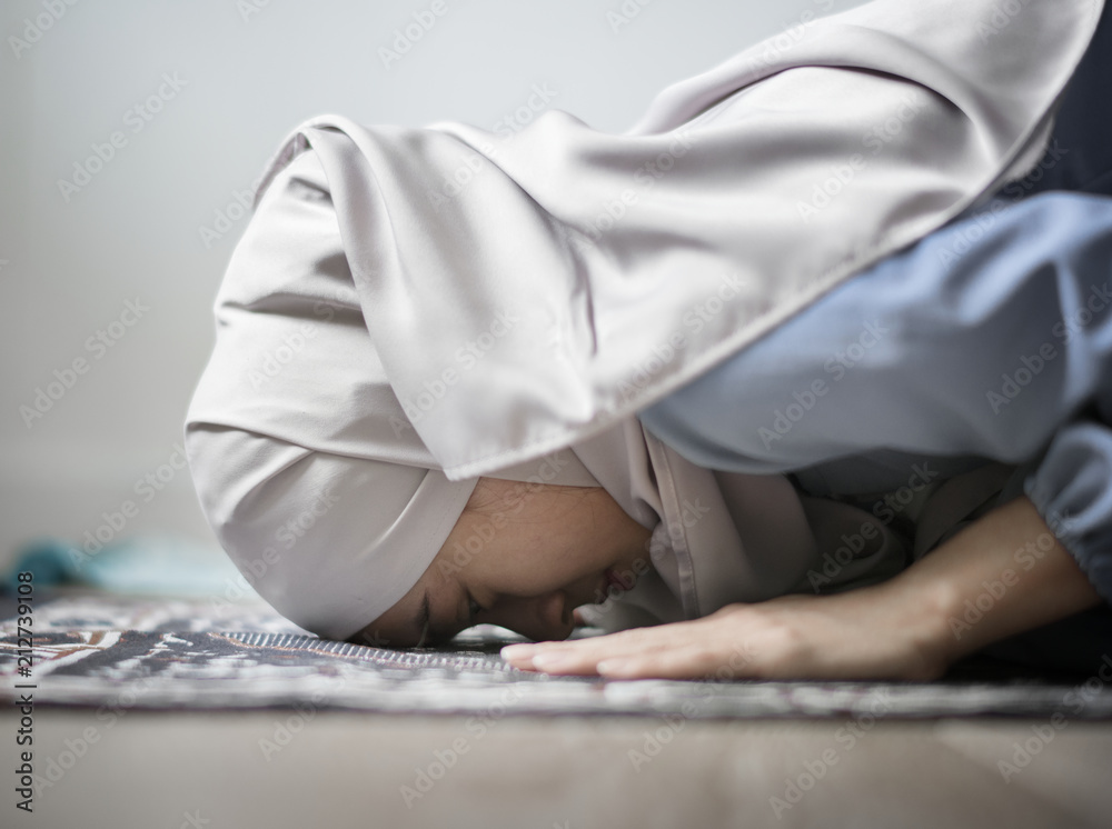 Muslim woman praying in Sujud posture Stock Photo | Adobe Stock