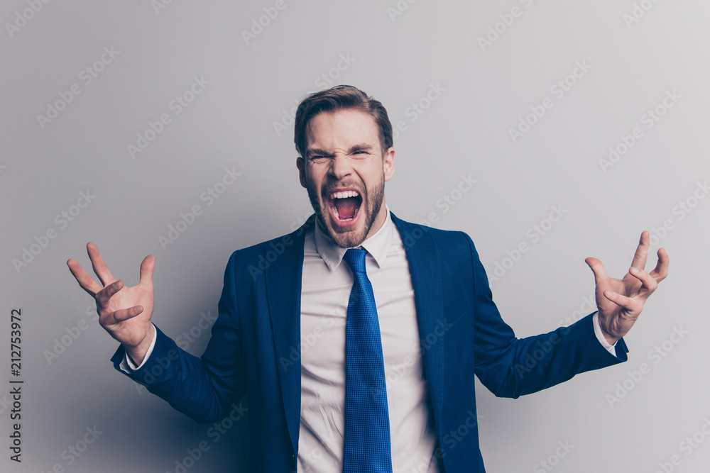 Portrait of violent, stylish, attractive, angry man in blue suit, tie ...