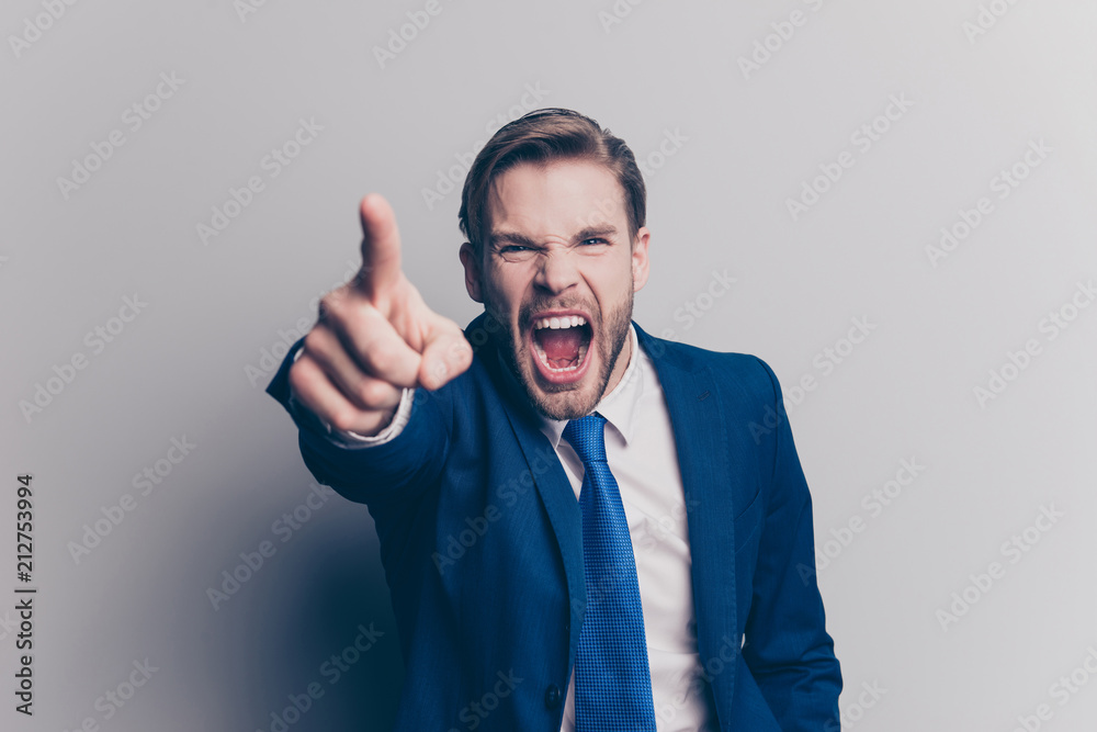 Portrait of violent, stylish, attractive, angry man in blue suit, tie ...