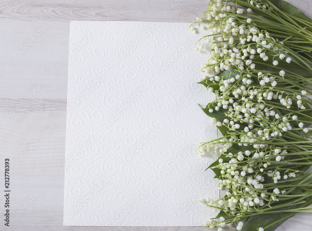white letter paper, lilies of the valley on a light background ...