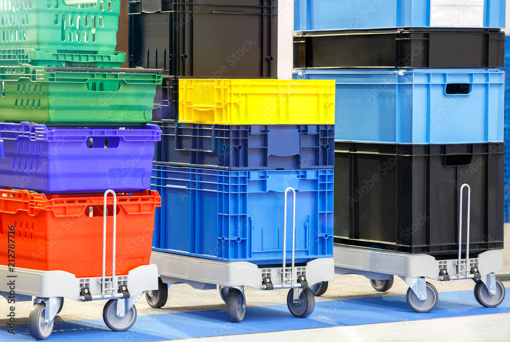colorful plastic boxes stacked one upon the other on warehouse trolley ...