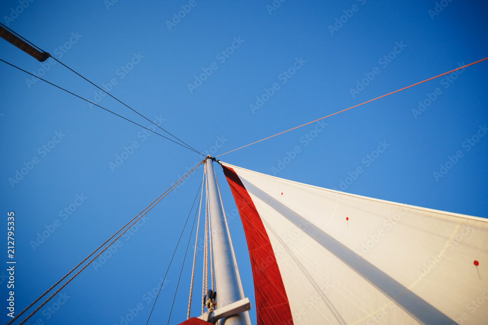 Top of the sailboat, mast head, sail and nautical rope yacht detail ...