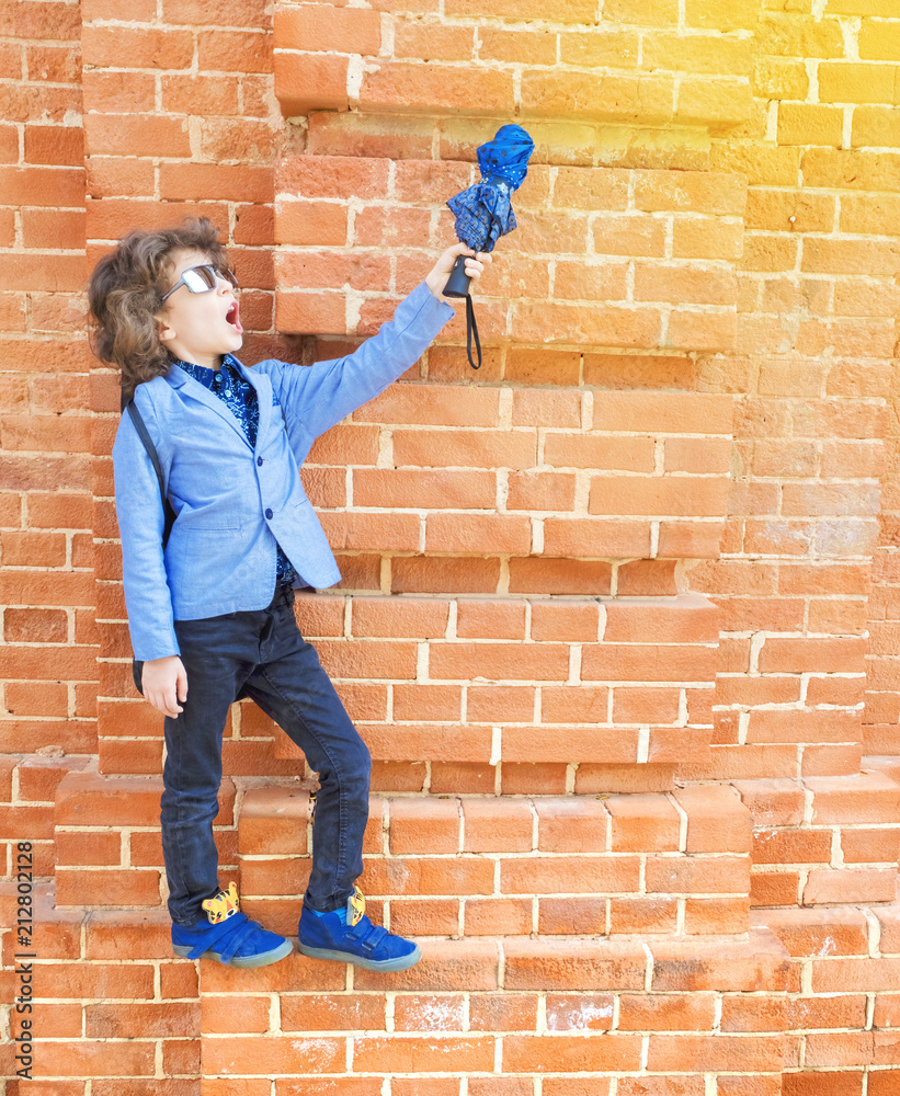 Cute little boy on brick wall background. Kids fashion concept Stock ...