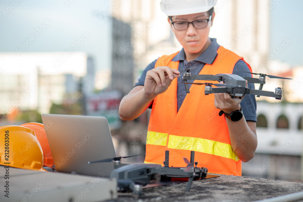 Young Asian man working with drone laptop and smartphone at ...