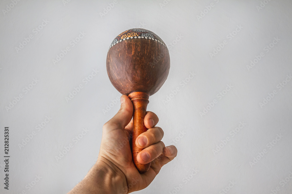 Male hand holding maracas in front of a white wall background Stock ...