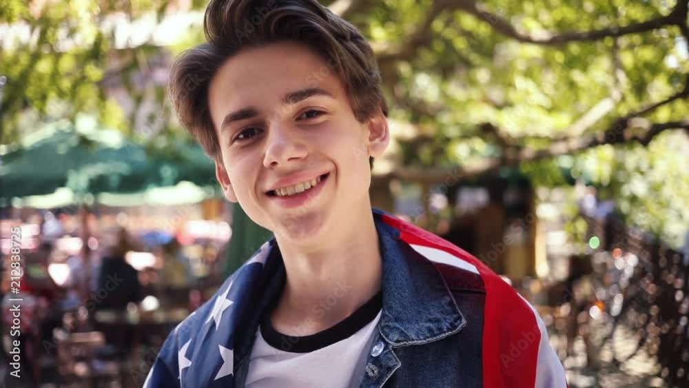 Portrait smile boy with american flag look at camera shot in slow ...