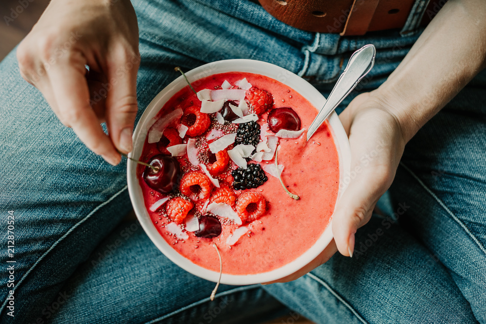 Woman eating healthy smoothie bowl Stock Photo | Adobe Stock