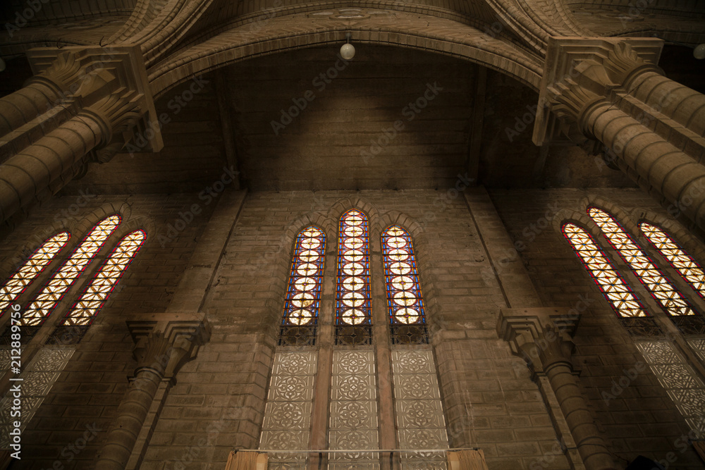 Old catholic church inside background with columns and stained-glass ...
