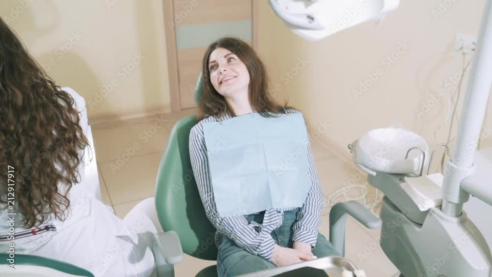 Slowly shooting steadicam smiling fearless patient in the dentist's ...