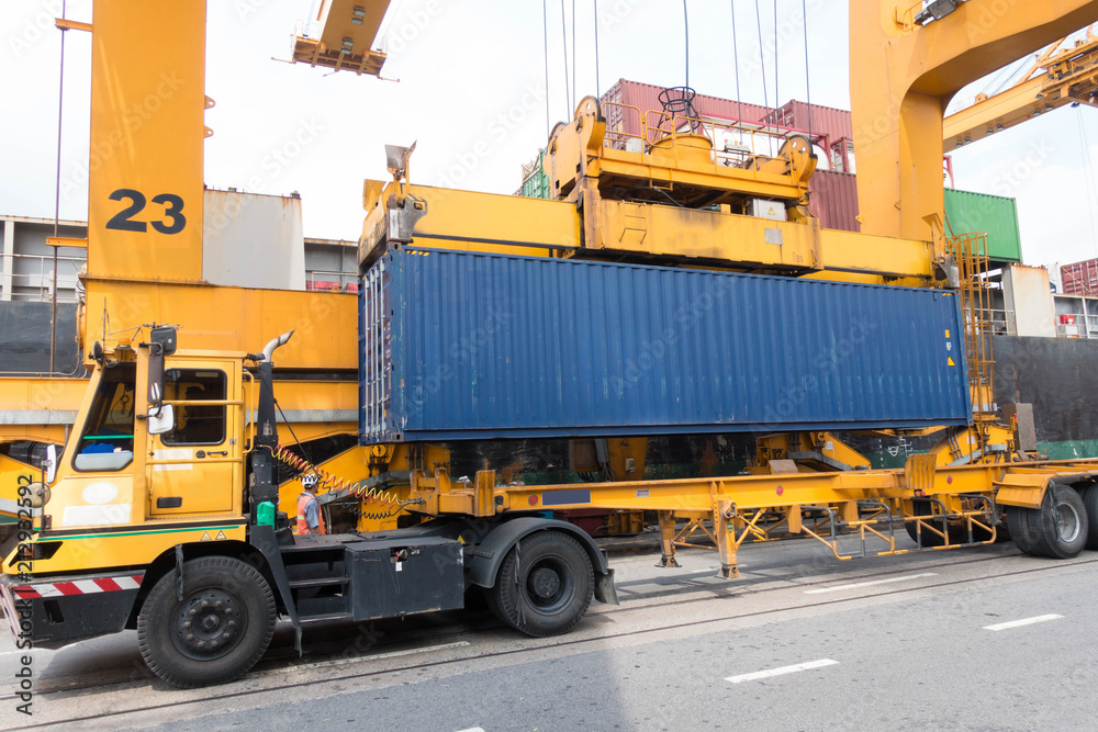 Cargo operation at port. Granty crane is lifing a container to put on ...