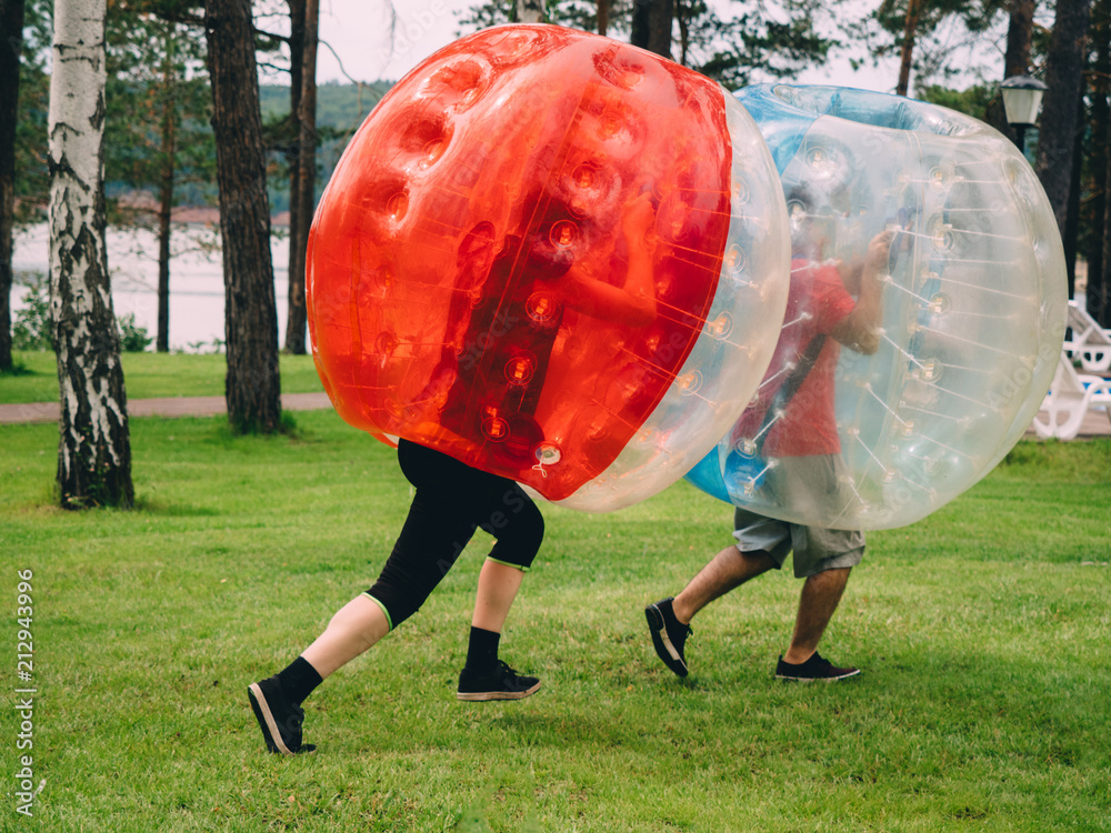 People play bumperball zorbsoccer outdoor. summer time Stock Photo ...