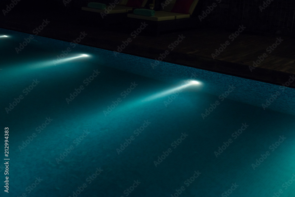 lighting fittings under water in swimming pool at night Stock Photo ...