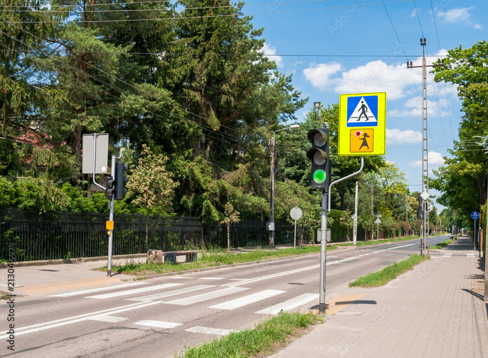 road with pedestrian crossing and traffic signs and traffic lights ...