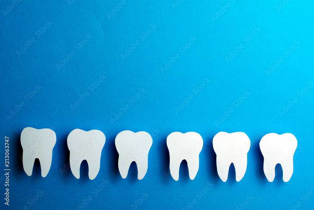 White healthy teeth over blue background with copy space. Dental care ...