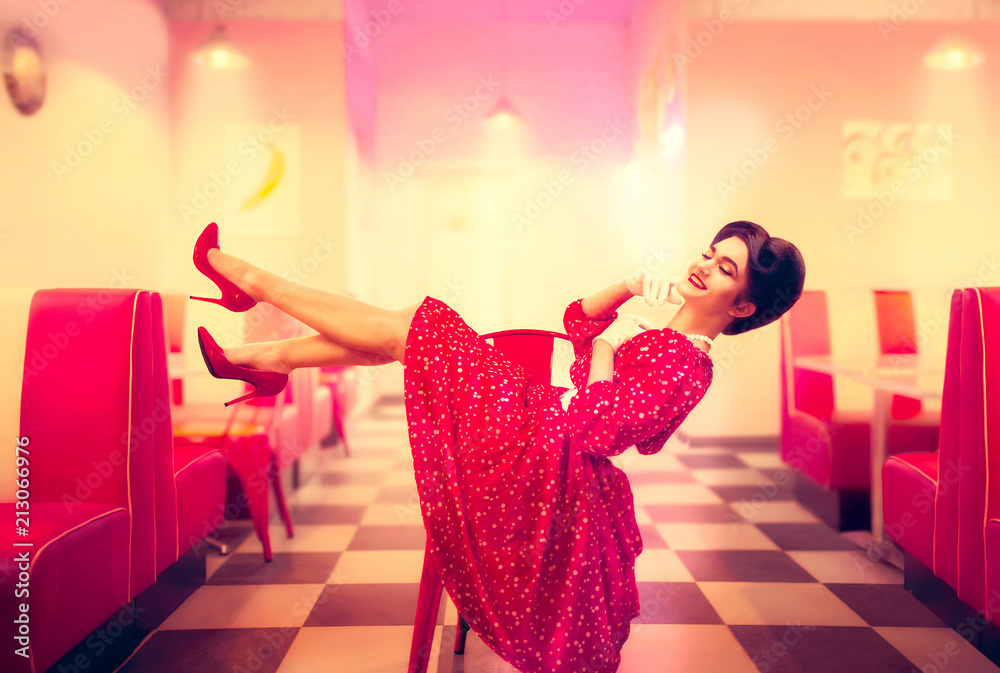 Sexy pin up girl with makeup posing in retro cafe Stock Photo | Adobe Stock