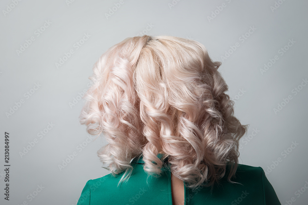 Hairstyle curls on the head of a blonde back view of turning the head ...