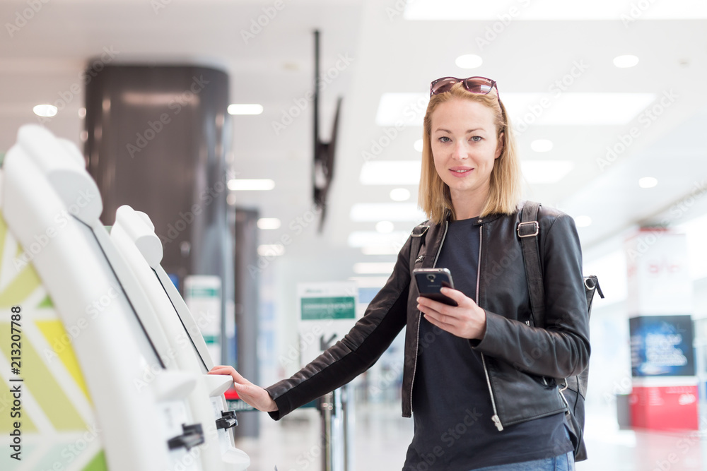 Casual caucasian woman using smart phone application and check-in ...