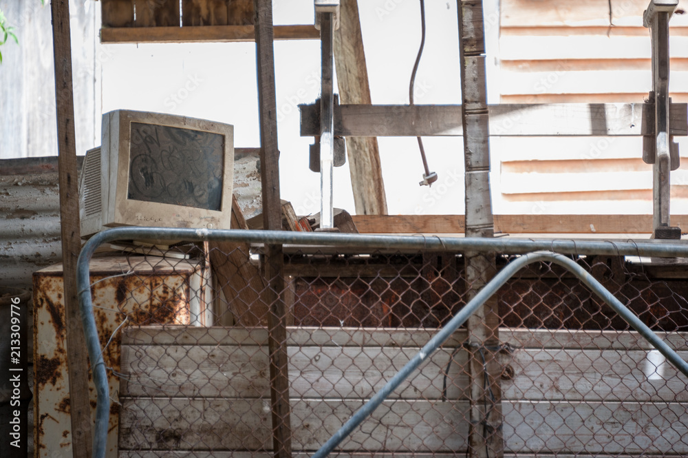 An abandoned CRT computer monitor, covered in dust, in an abandoned and ...