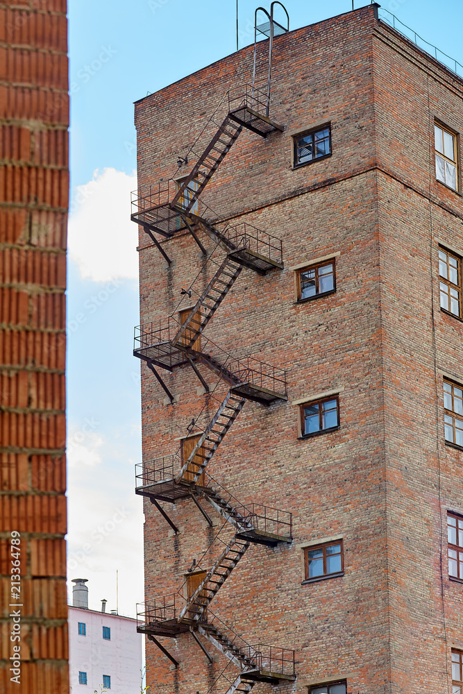 Fire escape ladders on outside of building facade. Stock Photo | Adobe ...