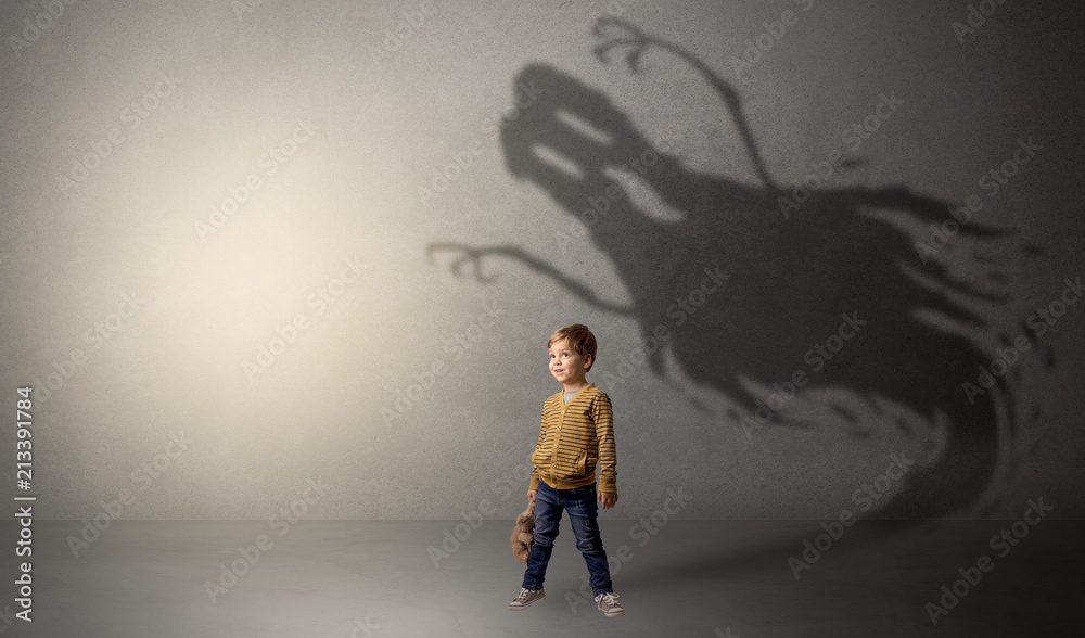Scary ghost shadow in a dark empty room with a cute blond child Stock ...