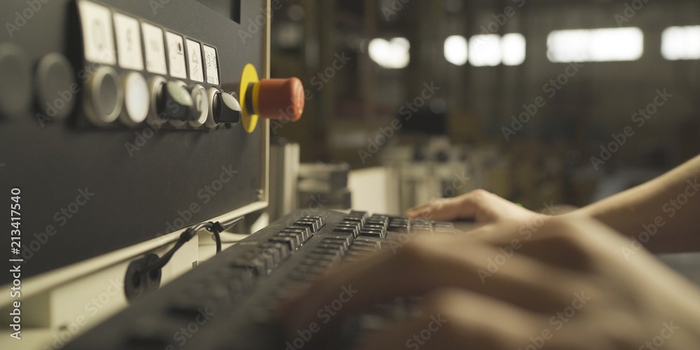 Factory Engineer Operating Hydraulic Tube Bender. The worker types the ...