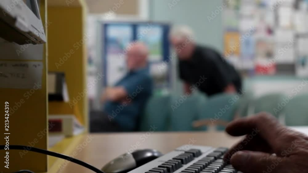 Patients sitting down in waiting room & keyboard typing in the ...