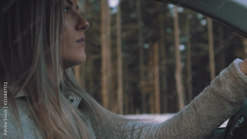 Girl driving in slow motion through the forest. Stock Video | Adobe Stock