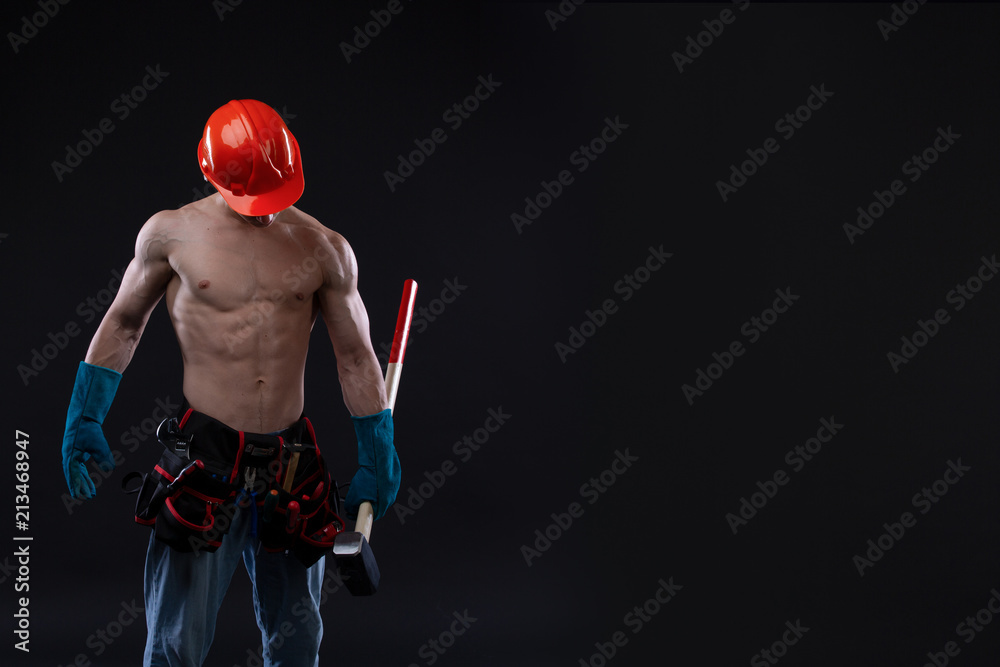 Handsome young topless construction worker with sledge hammer, studio ...