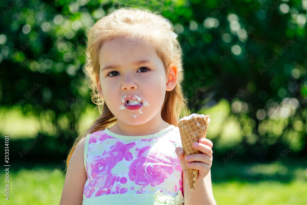 cute little kid girl eat smudge ice cream in a waffle horn smeared face ...