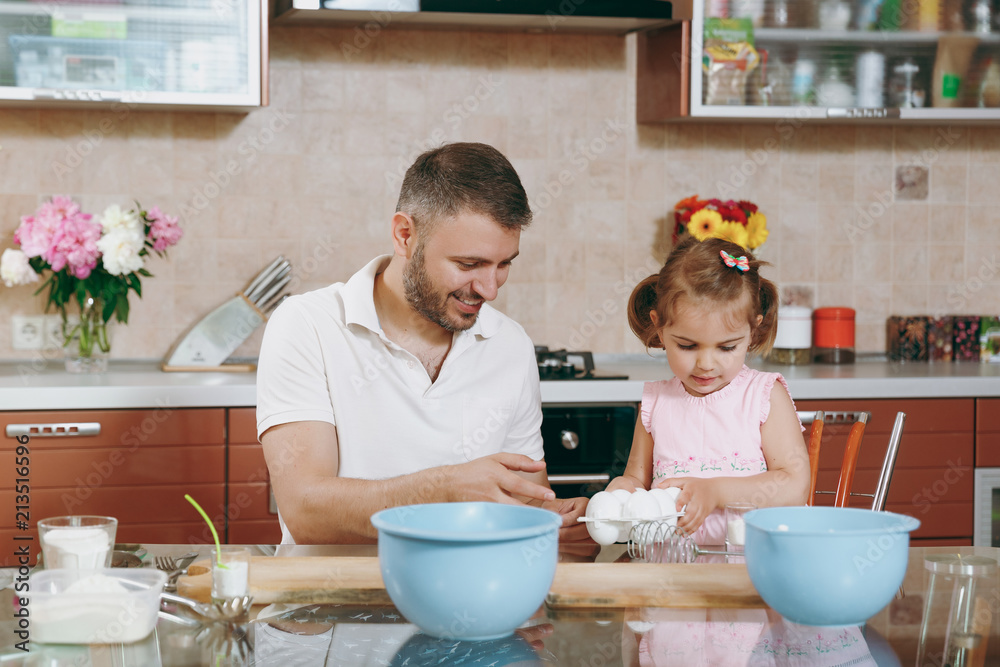 Little kid girl help man to cook Christmas ginger cookies, gives eggs ...