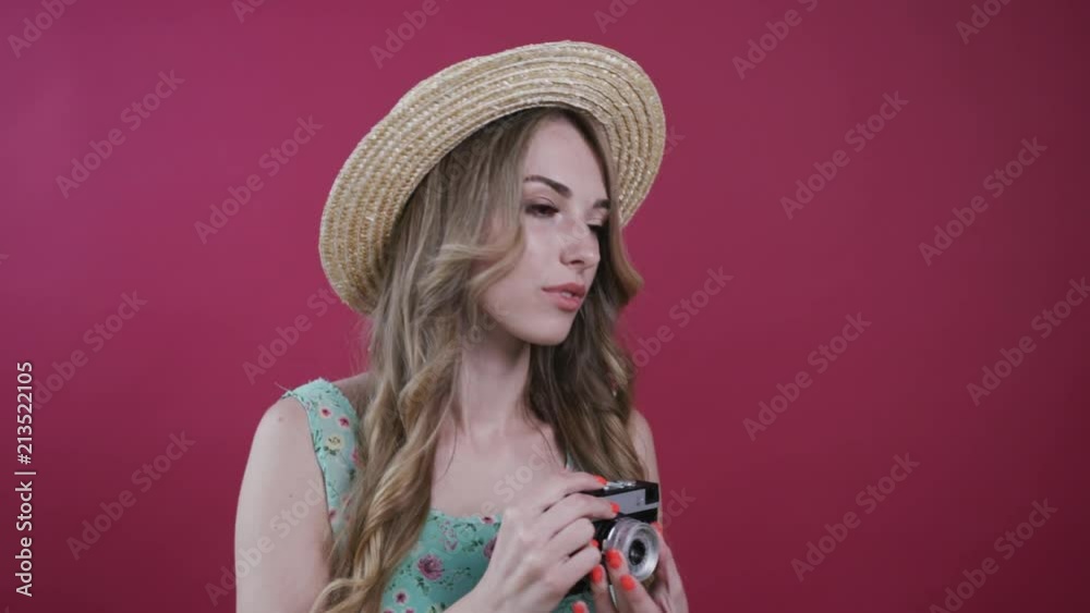 Beautiful young woman in straw head chooses the right angle to make a ...