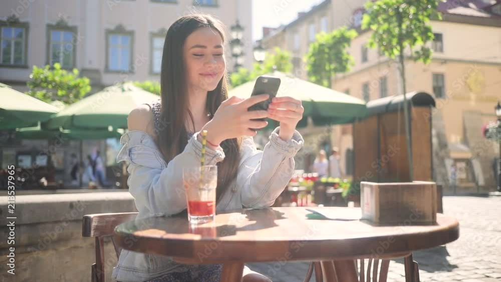 Beautiful positive Ukrainian girl with long straight brown hair holding ...