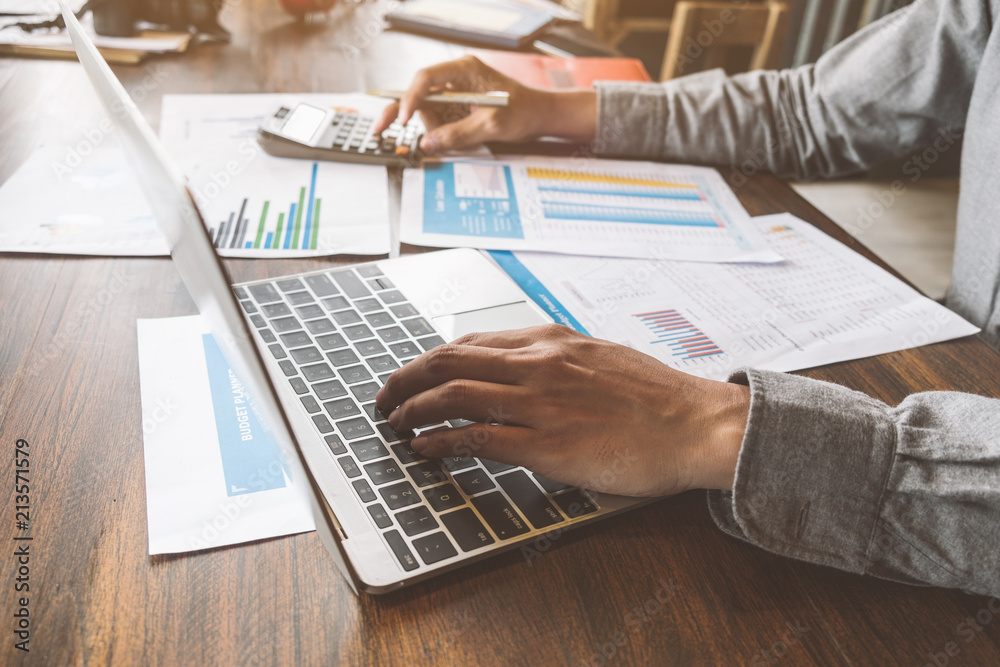 Business accounting, Businessman using computer laptop with document ...