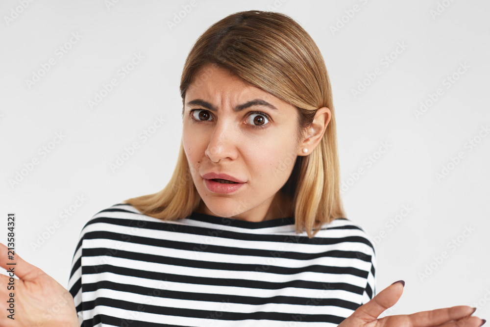 Fotka „What? Picture of indignant puzzled young woman raising her ... Fotka „What? Picture of indignant puzzled young woman raising her ...