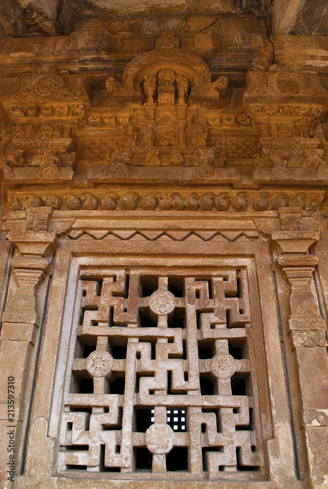 Carved window with the swastika design on the garbha griha wall, Aihole ...