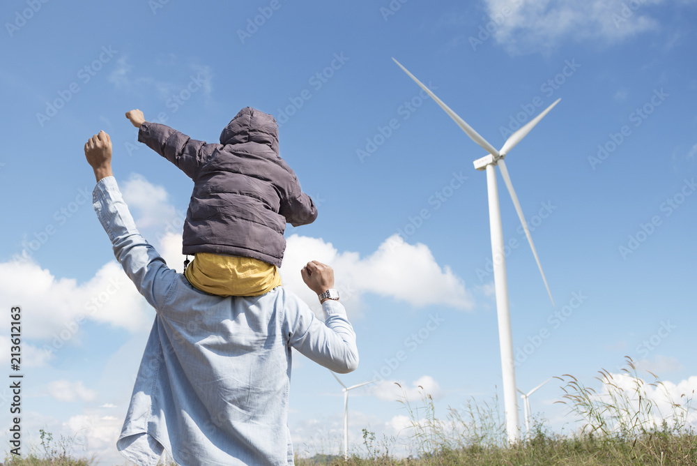 happy father and son playing at the Wind turbines generating ...