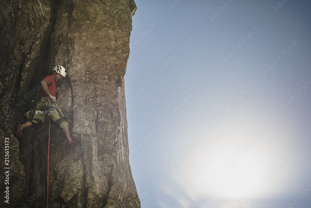 Climber climbing a granite crack and lens flare Stock Photo | Adobe Stock