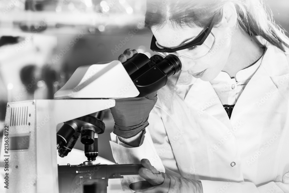 Life scientists researching in laboratory. Attractive female young ...