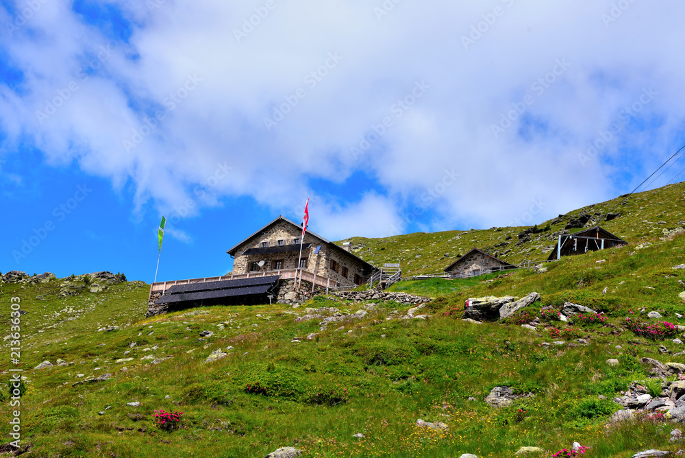 The Rifugio Lago Rodella / Radlseehütte with its emblem / flag of the ...