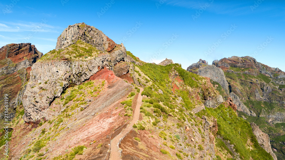 Colorful mountain ridge path with volcanic formation in background ...