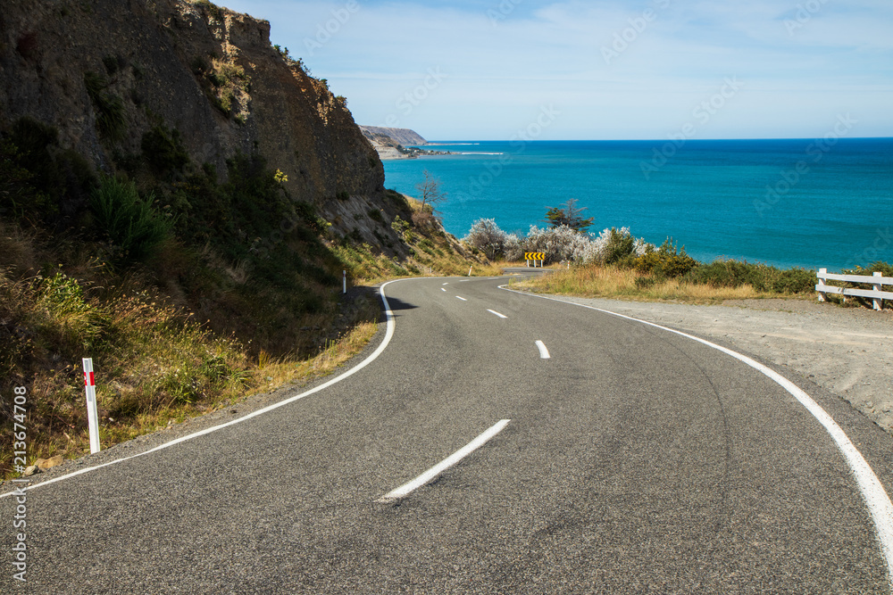 Road leading to a bay. Crystal clear water, amazing landscape. Windy ...