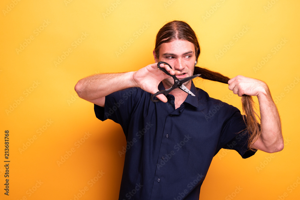Angry man decided to cut his long hair with scissors Stock Photo ...