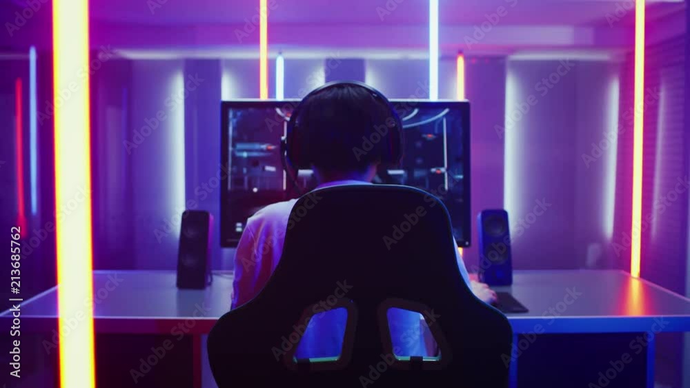 Back View Zoom Out Shot of the Professional Gamer Playing in First ...
