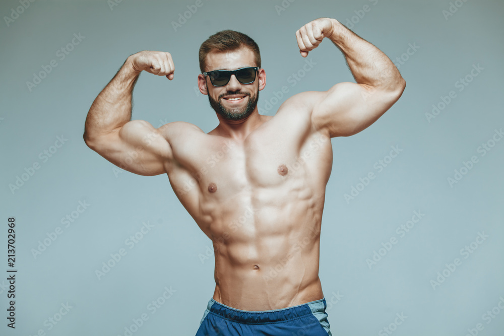 .bodybuilder posing. Beautiful sporty guy male power. Fitness muscled ...