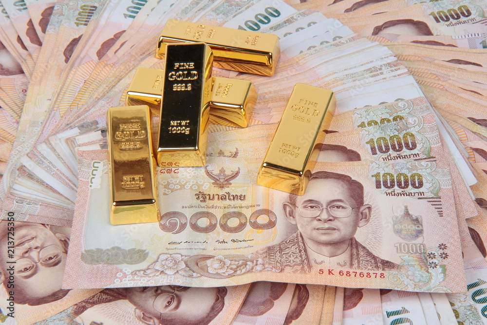 5 of 1 kg. Gold bar on 1000 Baht of Thailand banknotes nested a pile ...