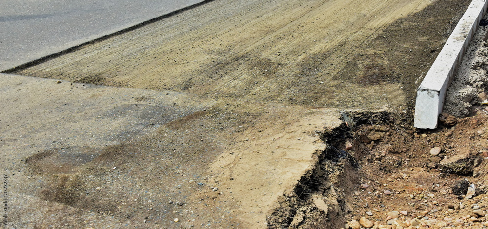 Repair of the highway. Installation of a new curb and asphalt pavement ...