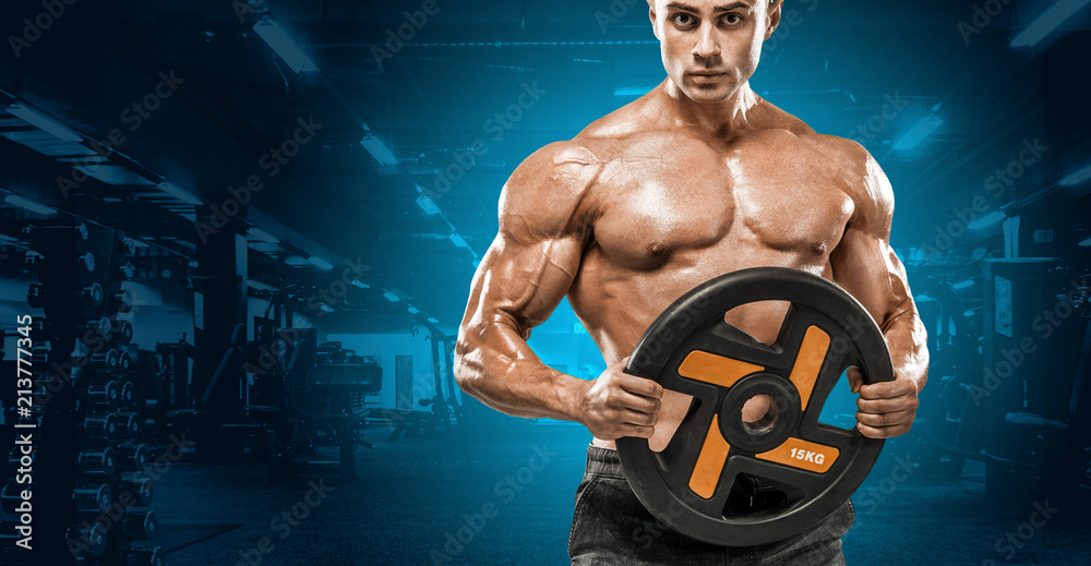 Brutal strong muscular bodybuilder athletic man pumping up muscles ...